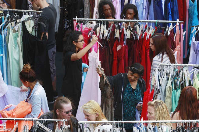‘Operation Glass Slipper’ - Women look through racks of dresses during ...