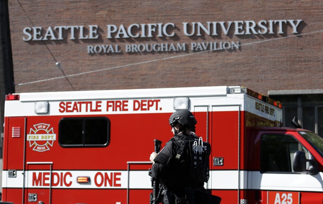 Seattle campus shooting - A Seattle police SWAT team member walks ...