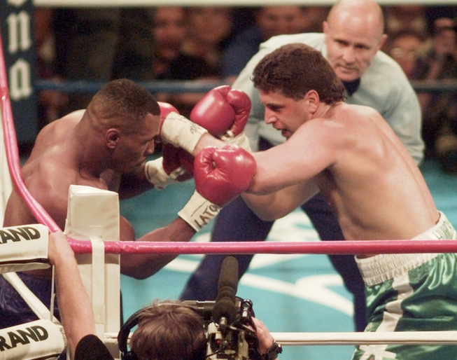 Boxing Throughout the Years - Mike Tyson, left, takes a punch from ...