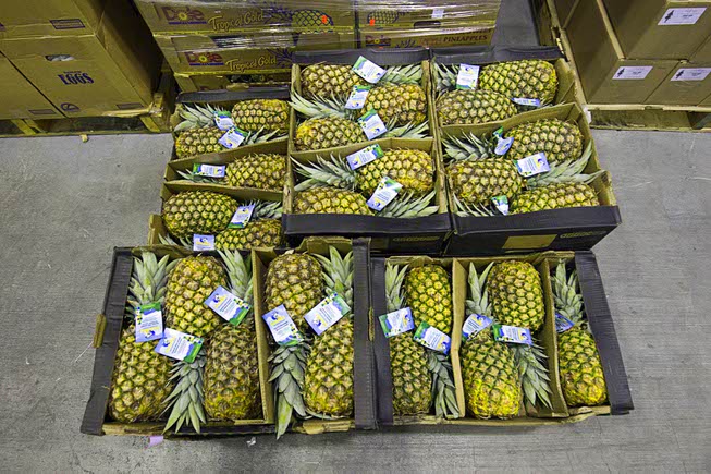 Aria Warehouses and Delivery Dock Tour - Boxes of pineapples are shown ...