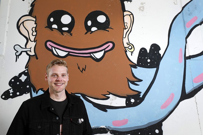 Ryan Brunty - Local street artist Ryan Brunty poses in front of one ... -