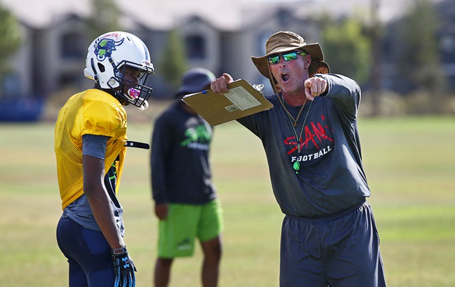 Slam Football - Coach Mike Cofer goes over a play during Slam (Sports ... -