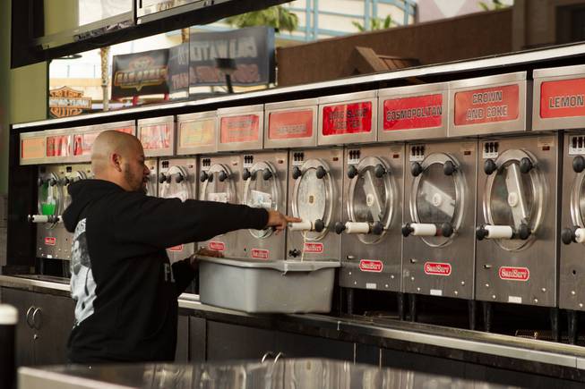 Downtown Casinos Begin Temporary Closures - Bartender Eric Razo cleans ...