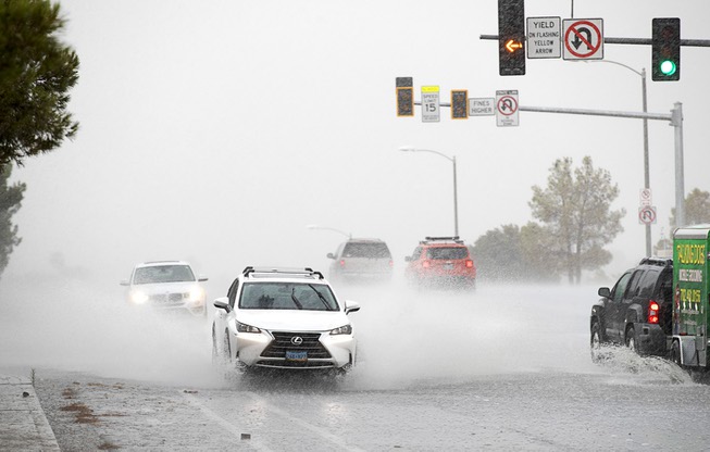 Storm Brings Rain, High Winds - Cars drive through storm runoff at ...