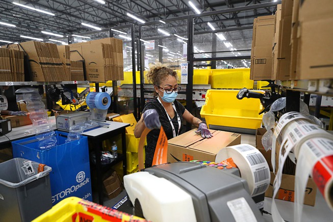 Amazon Warehouse Tour - Marisol C. LaRue works at a packing station ...