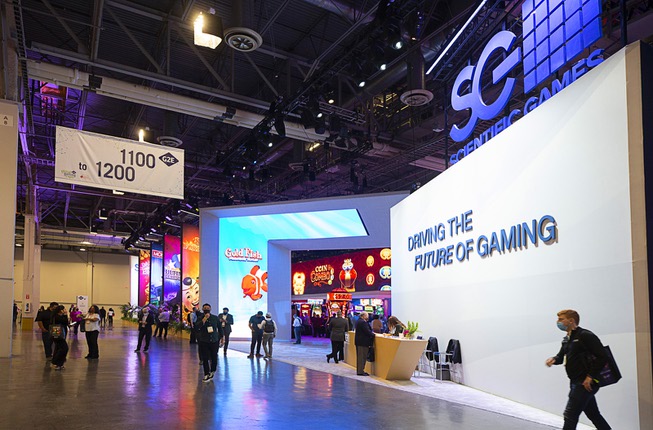 2021 Global Gaming Expo (G2E) - Attendees pass by the Scientific Games ...