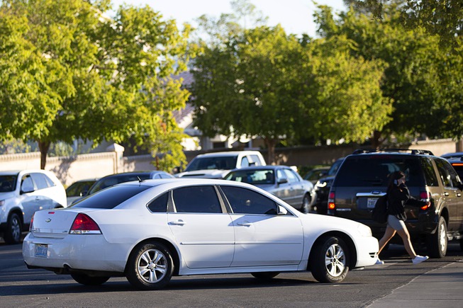 School Drop-off Traffic - A driver looks for curb space to drop off a ...