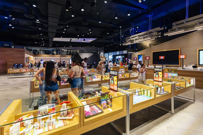 Planet 13 Cannabis Consumption Lounge - Customers browse products at ...