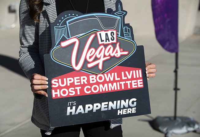 NFL Business Connect News Conference - A guide holds a sign promoting ...