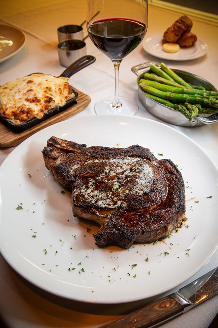 Delmonico Steakhouse - 20oz Prime Bone-in Ribeye with potato au gratin ...