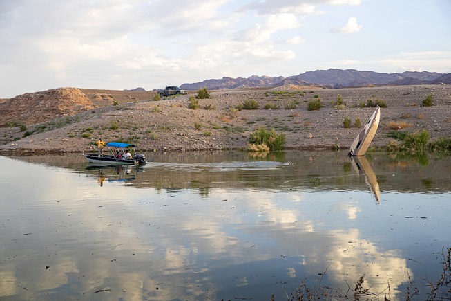 Vertical Boat Back in the Water - A fishing boat passes by the vertical ...