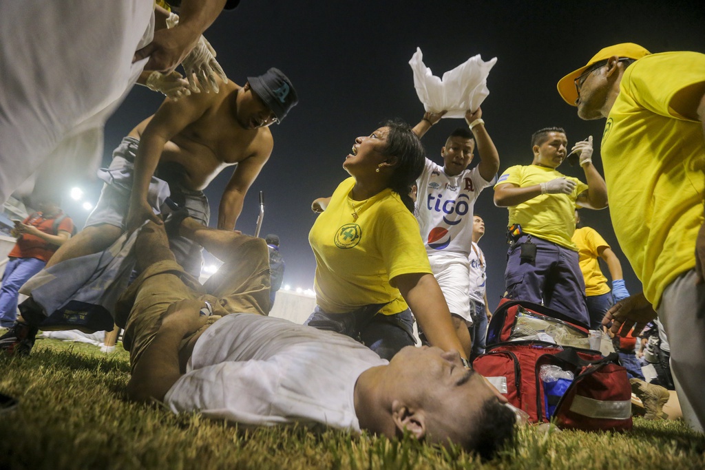 Fans crash through gate at El Salvador soccer match in stampede that ...