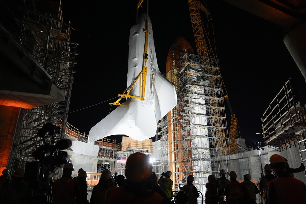 Space shuttle Endeavour hoisted for display in launch configuration at ...